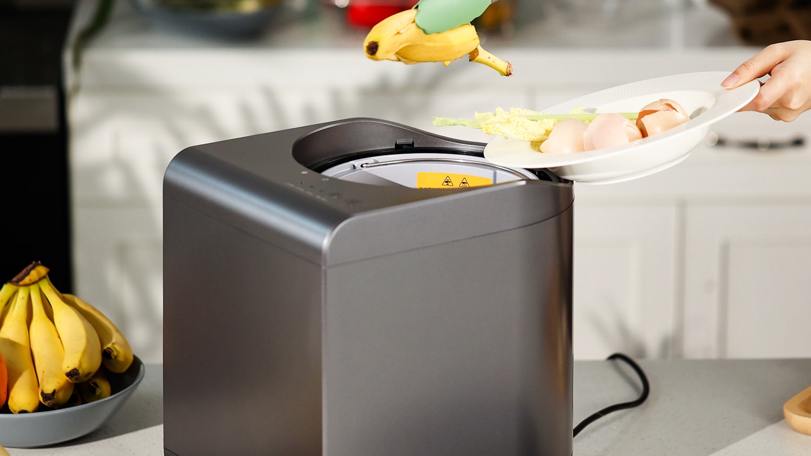 This electric kitchen composter recycles food scraps into garden gold